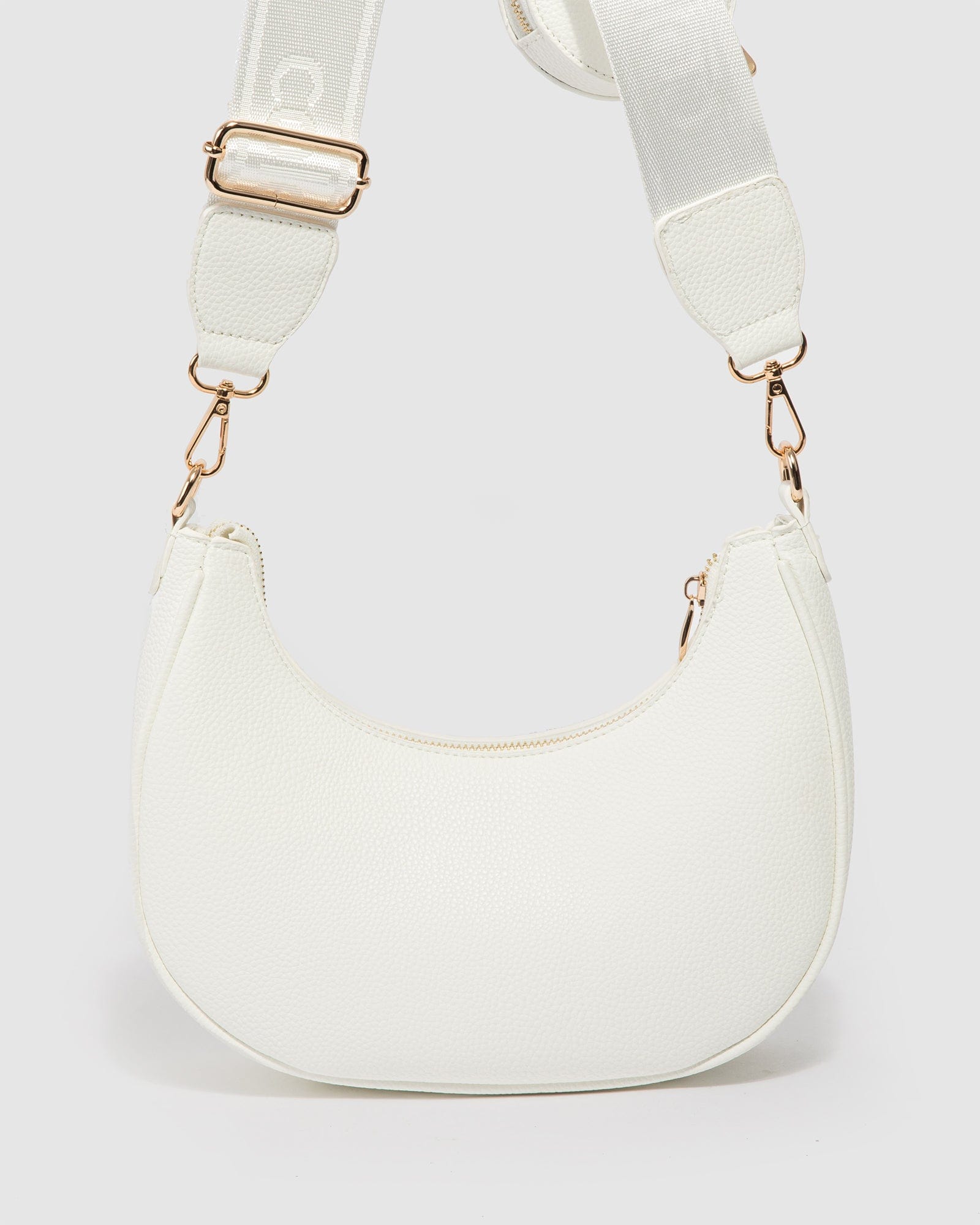 White Flavia Webbing Crossbody Bag with Gold tone Hardware | Colette Hayman
